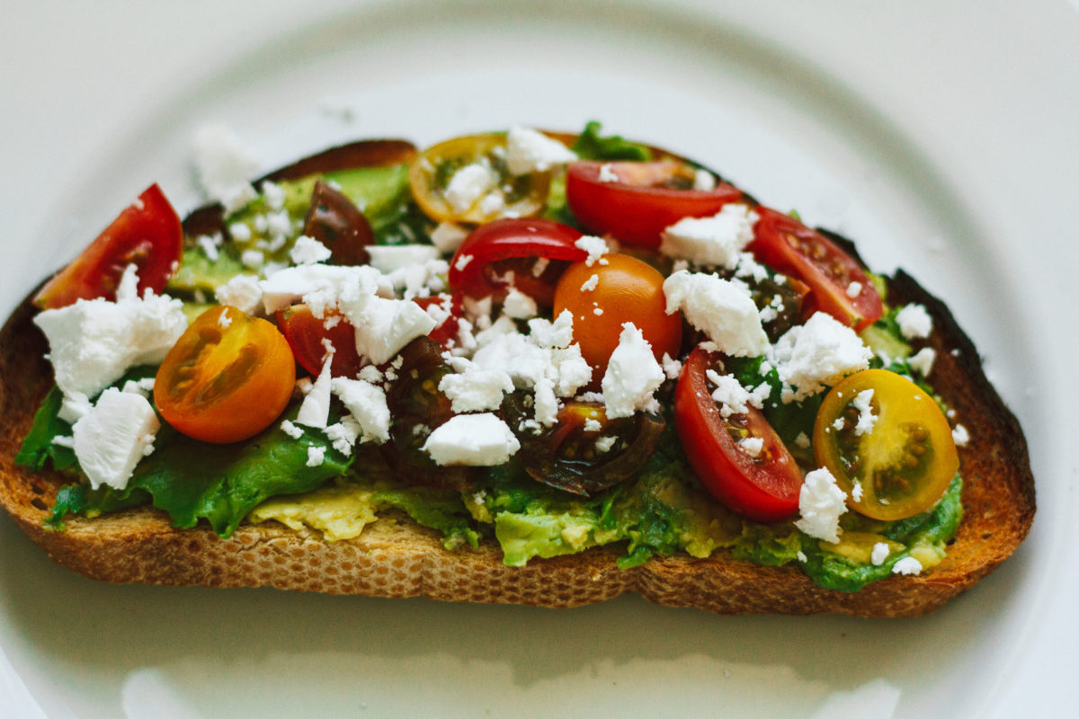 Avocado Toast with Heirloom Cherry Tomatoes, Vegan Feta, Arugula, and a ...